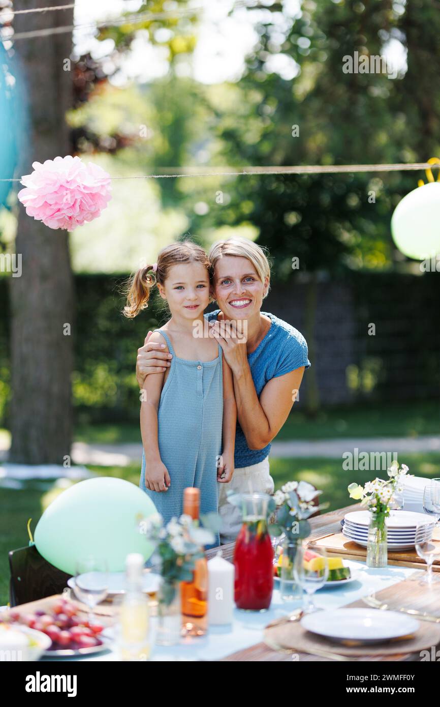 Family portrait at outdoor summer garden party. Aunt with niece ...
