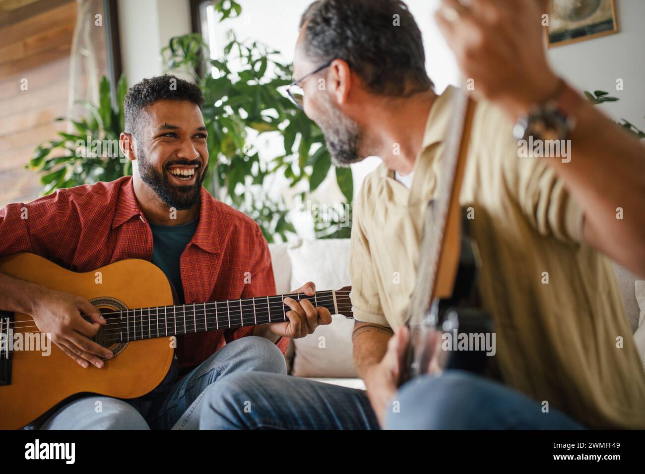 Best friends, musician jamming together. Playing music on guitar ...