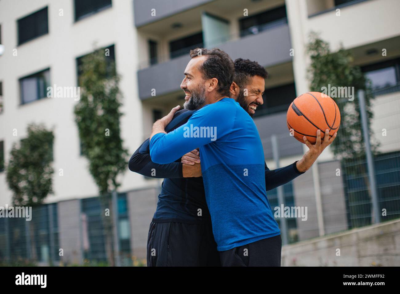Best friends playing sport outdoors, having fun, hugging after game ...