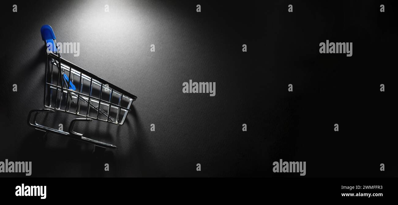Supermarket cart with spotlight on it on a dark background Stock Photo ...
