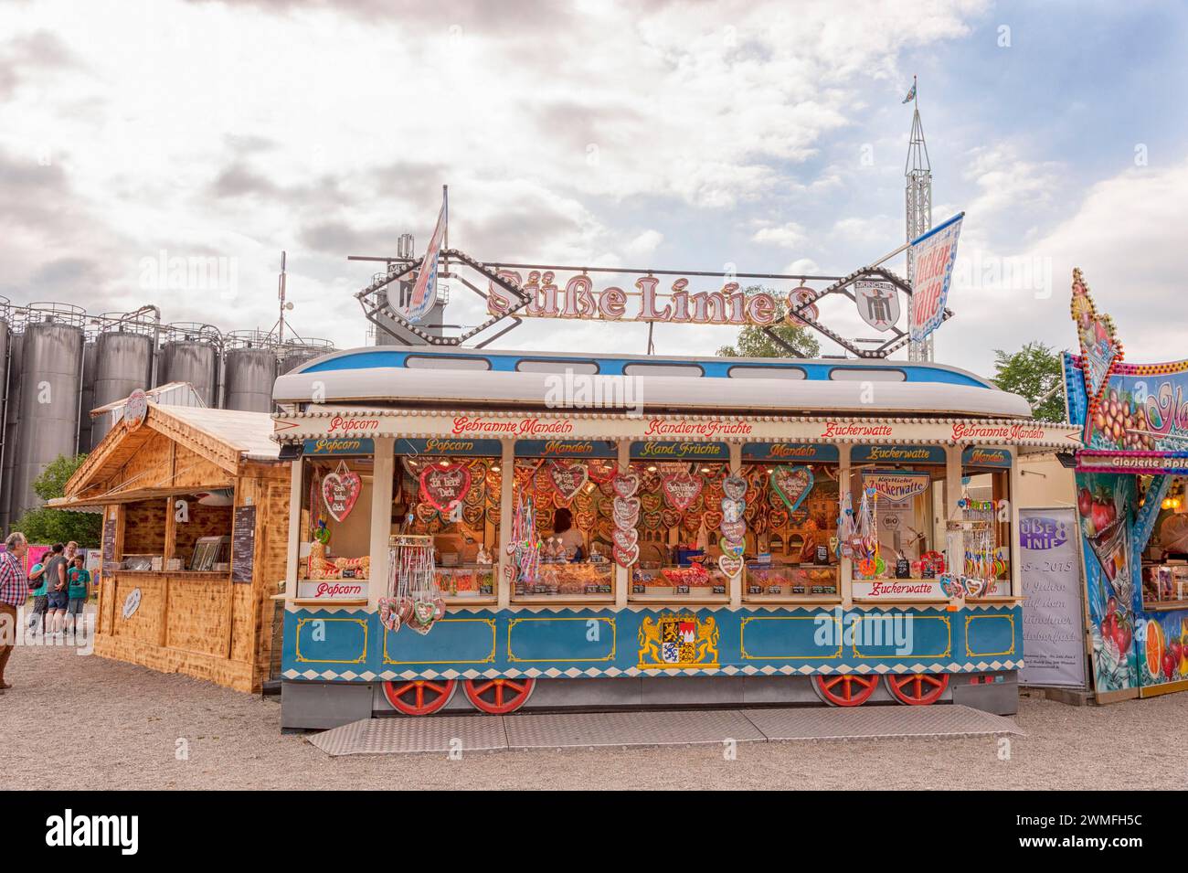 Folk festival and funfair stand, shape of Bavarian tram, almonds ...