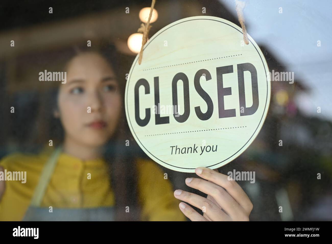 Store owner turning closed sign hi-res stock photography and images - Alamy