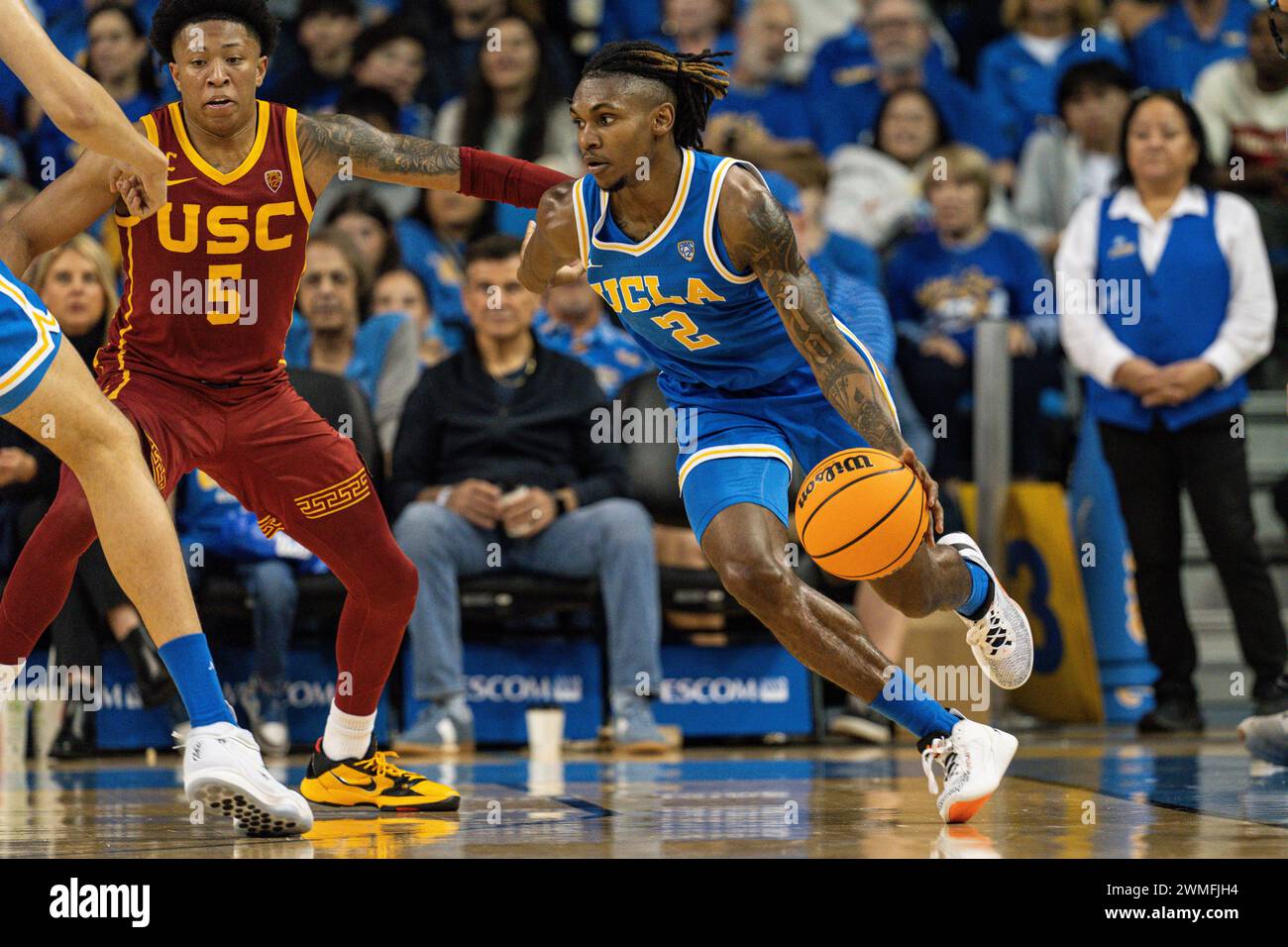 UCLA Bruins guard Dylan Andrews (2) is defended by USC Trojans guard ...
