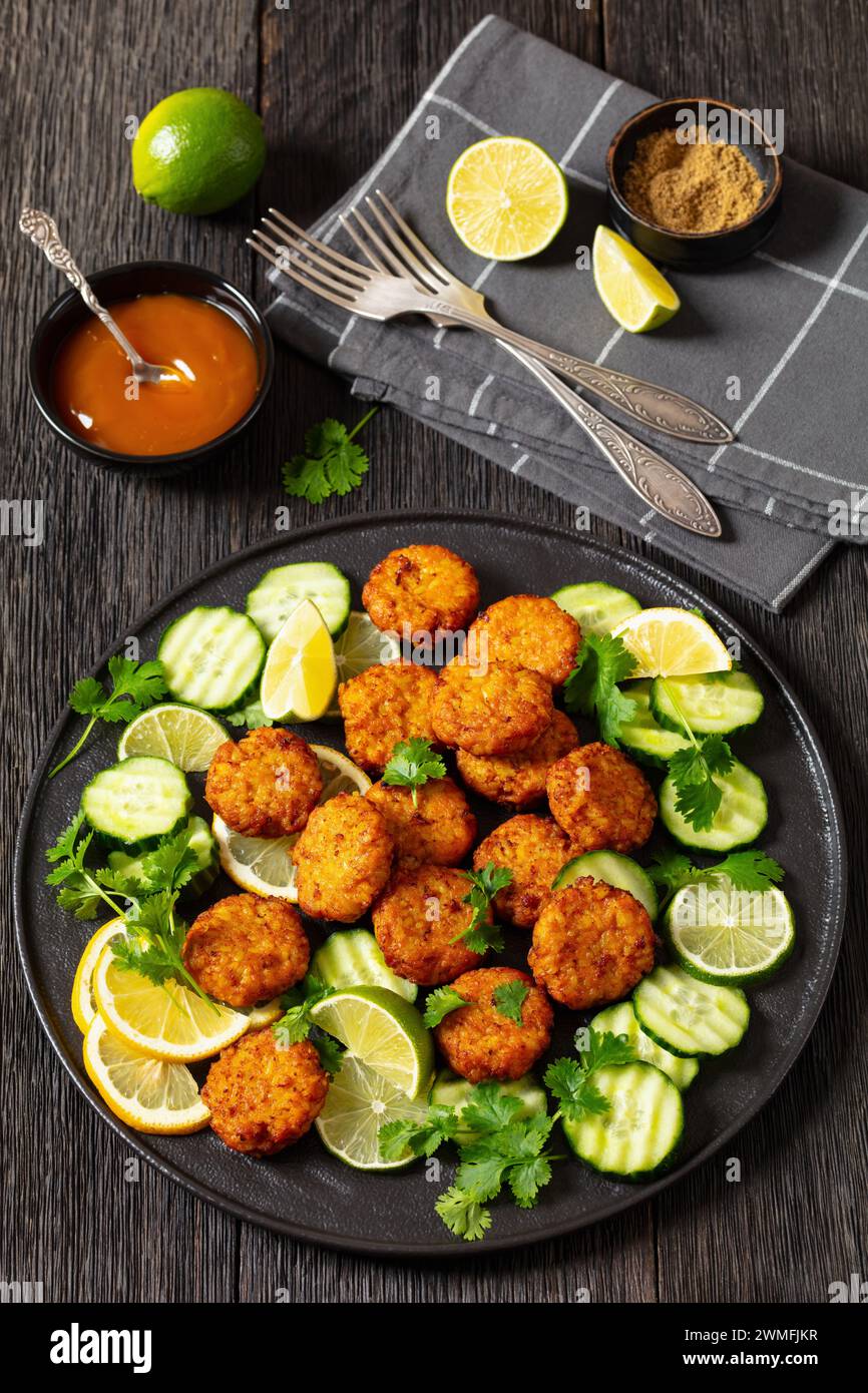 fried rice cakes, rice tikki, indian style on black plate served with ...