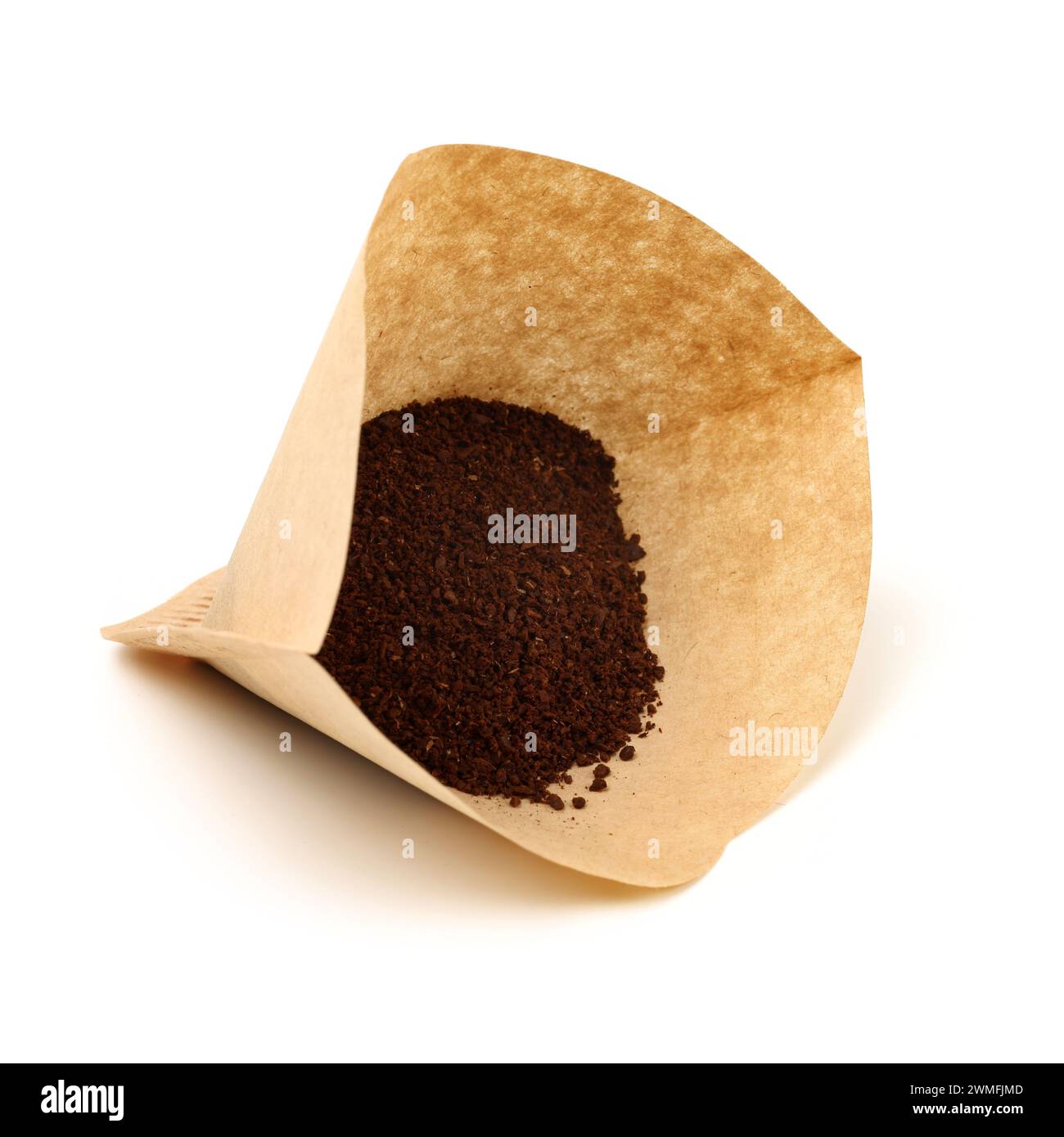 Coffee cone with filter paper full of coffee on white background Stock ...