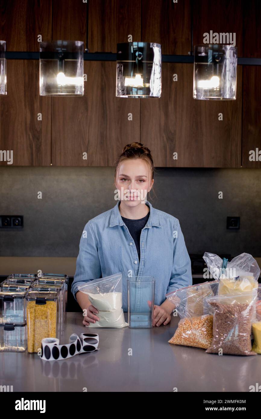 A woman uses containers to organize food in the kitchen. Layout and ...