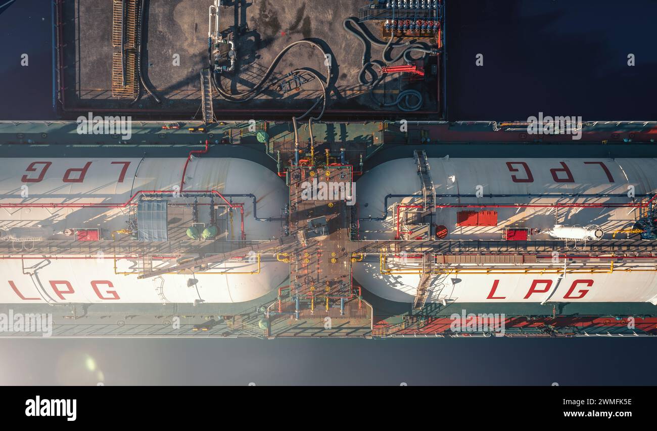 Aerial top view of red and white LPG tanker ship at sea in sunlight ...
