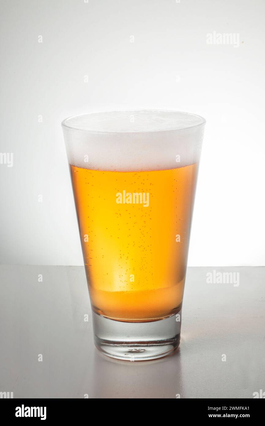 A vertical of a glass of beer on a table Stock Photo - Alamy