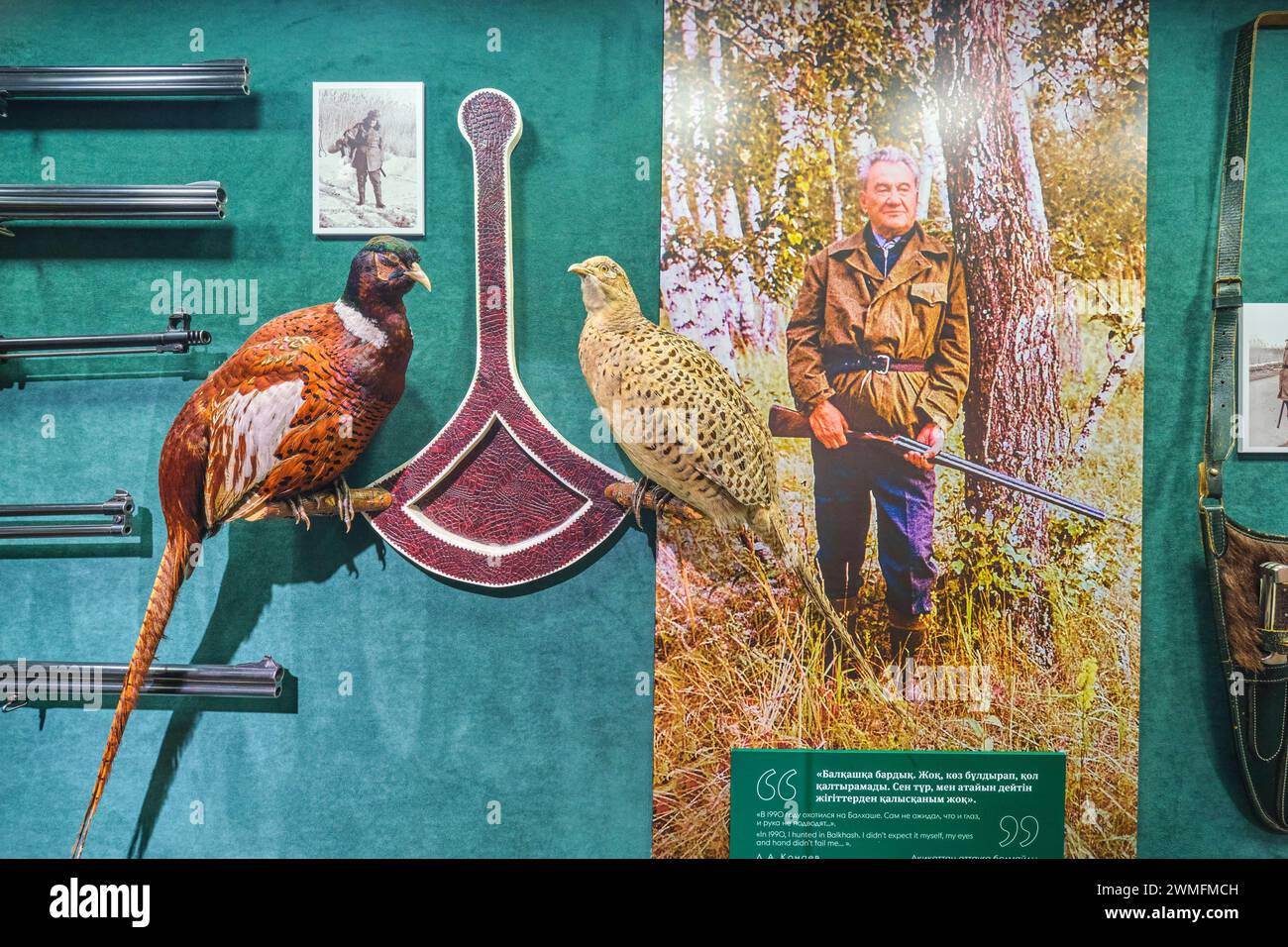 A photograph of Kunaev hunting and a couple of taxidermy, stuffed birds ...