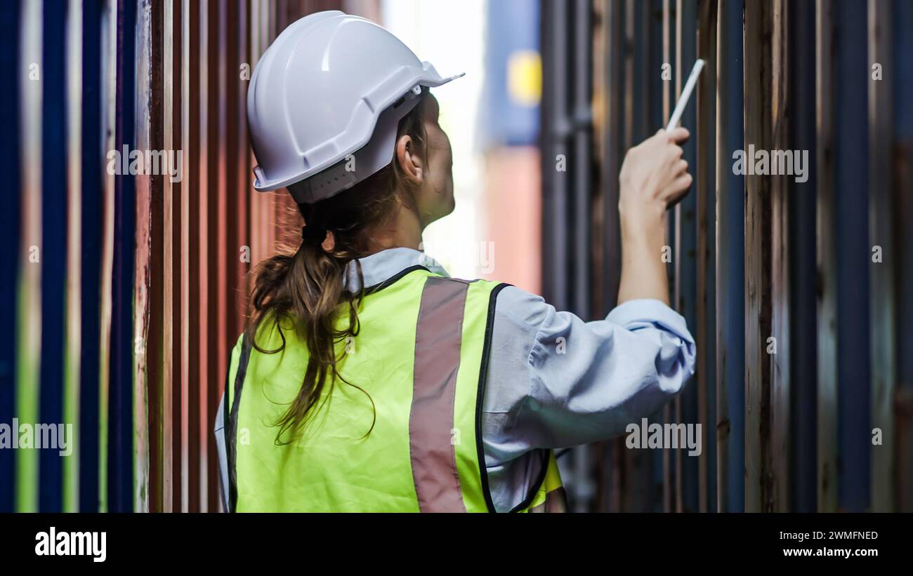 A female dock worker checking the cargo containers Stock Photo - Alamy