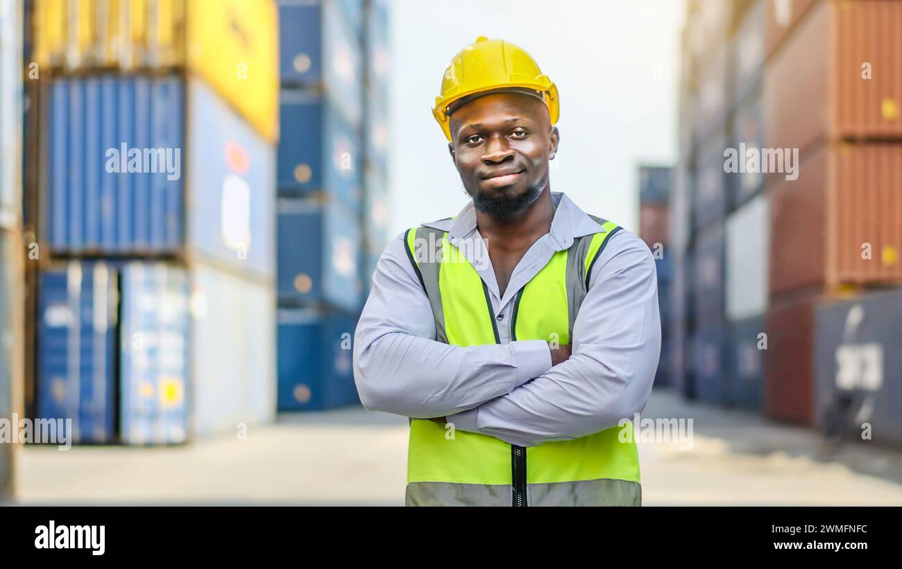 A dock foreman standing in front of cargo containers, posing for the ...