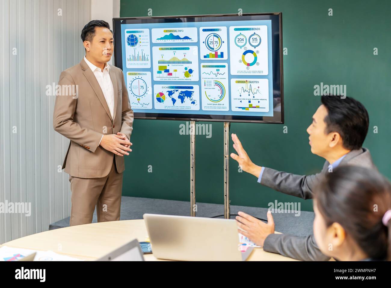 A man presenting company data on a big screen with charts and graphs ... A man presenting company data on a big screen with charts and graphs ...