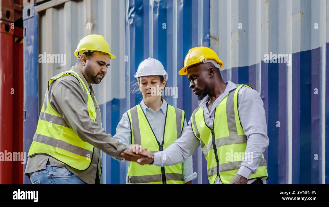 The dock workers stand with their hands together in the container ...