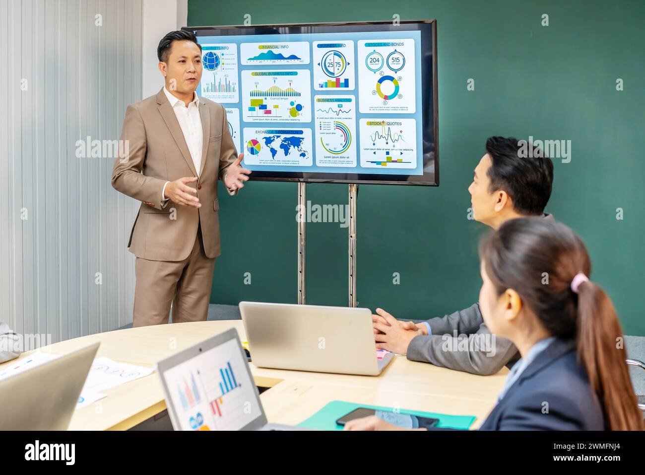 A man presenting company data on a big screen with charts and graphs ... A man presenting company data on a big screen with charts and graphs ...