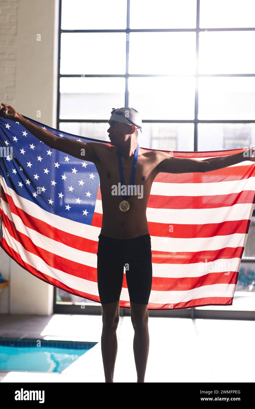 Young biracial male athlete swimmer celebrates victory at a swimming ...