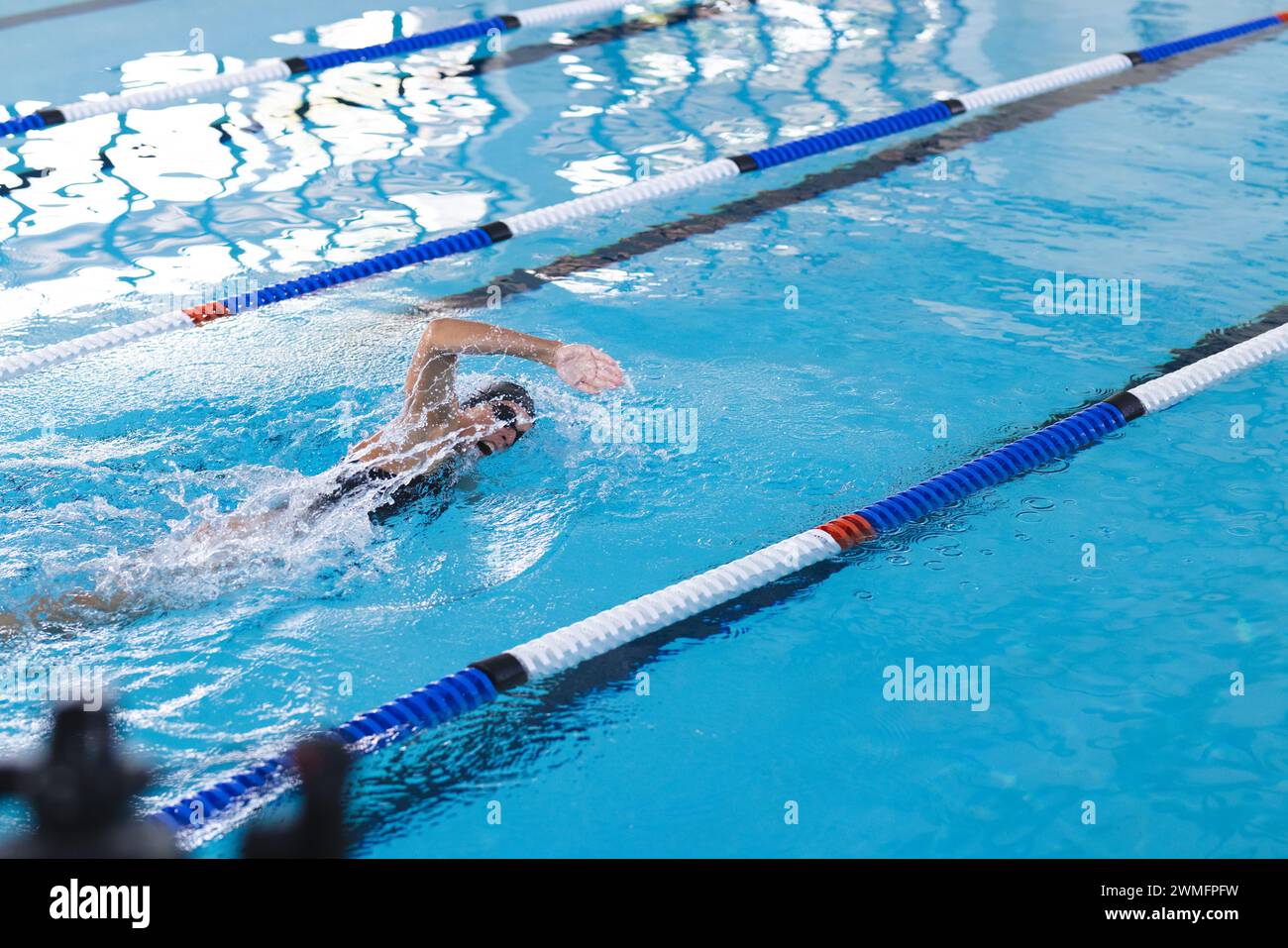 Swimmer in action at an indoor pool, with copy space Stock Photo - Alamy