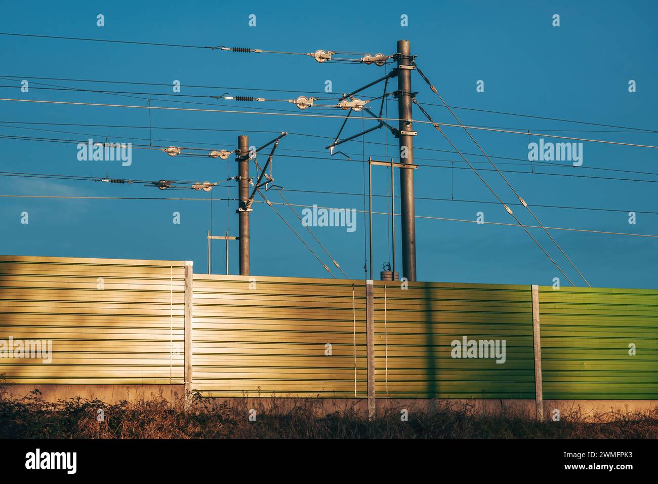 Electric train railway line tension pole with wires and concrete ...