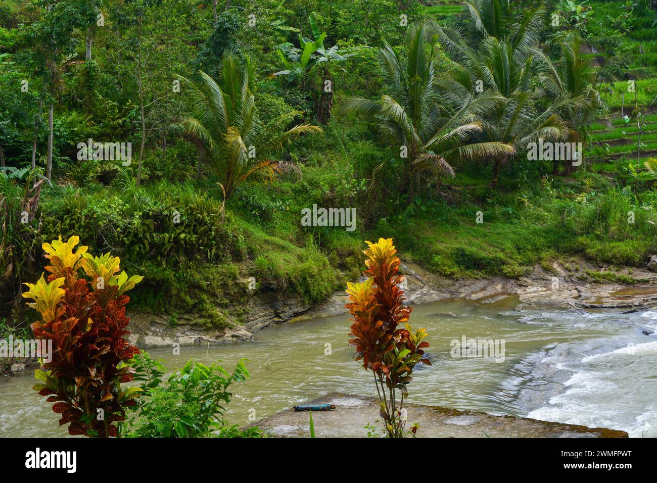 A fast-flowing stream and dramatic lenticular clouds against a dark sky ...
