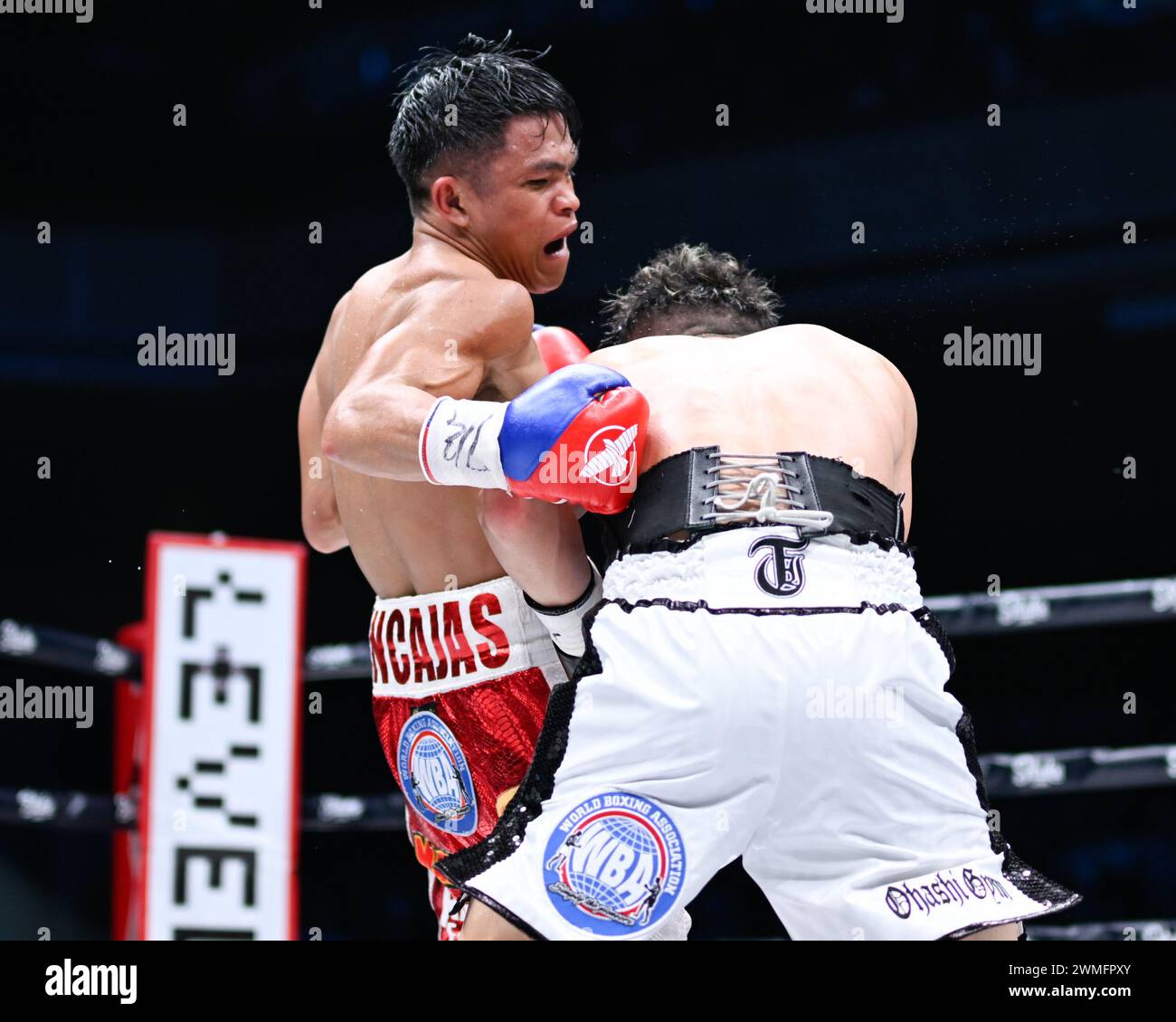 Champion Takuma Inoue (black gloves) of Japan and challenger Jerwin Ancajas (red/blue gloves) of ...