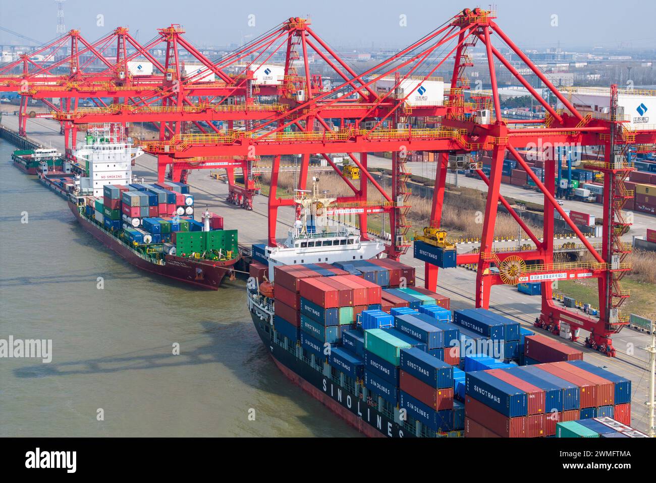 NANJING, CHINA - FEBRUARY 26, 2024 - Container cranes unload containers ...