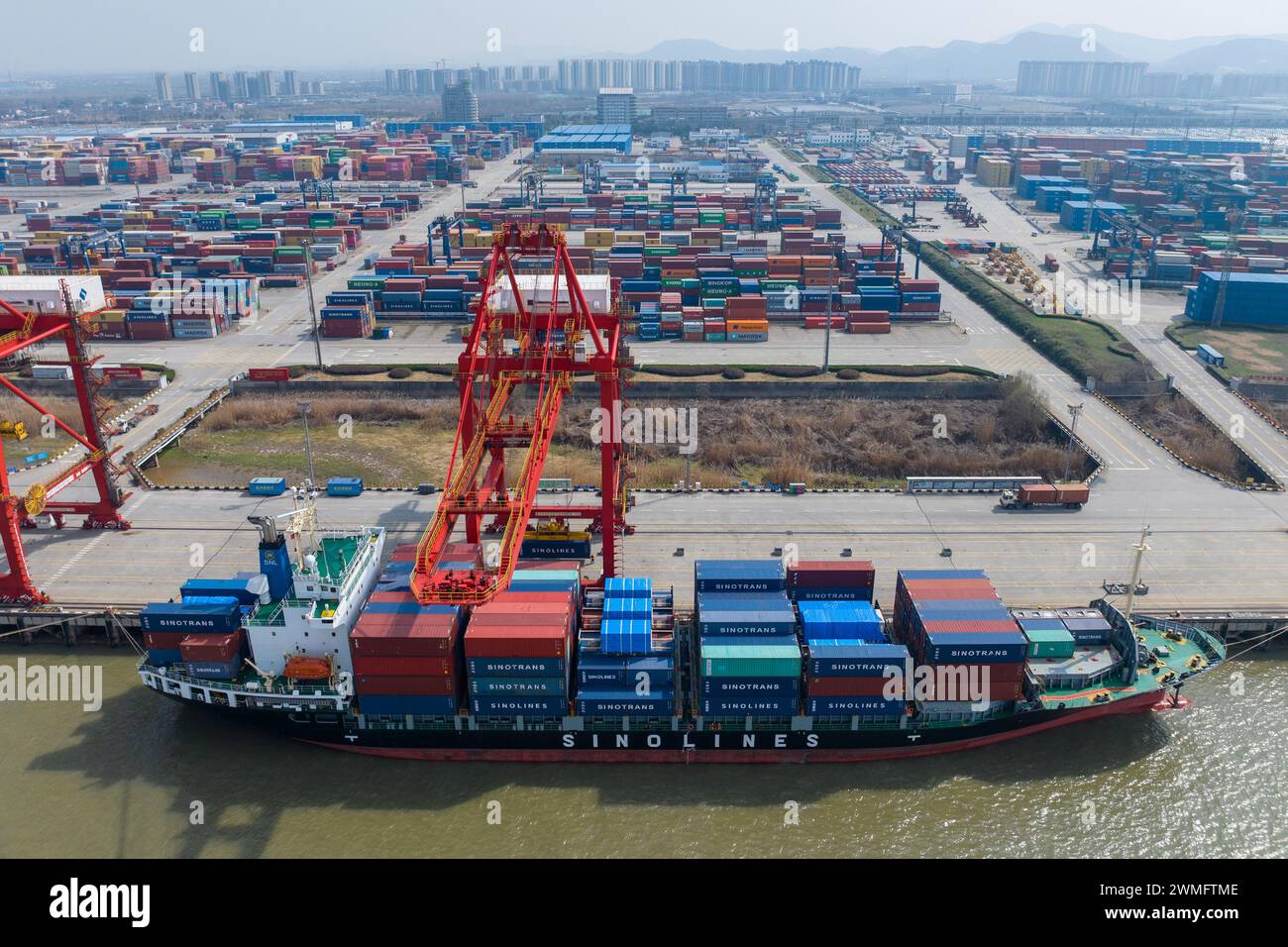 NANJING, CHINA - FEBRUARY 26, 2024 - Container cranes unload containers ...