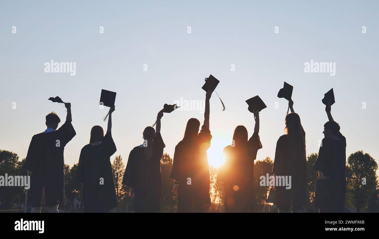 Silhouettes of college graduates waving their caps at sunset Stock ...