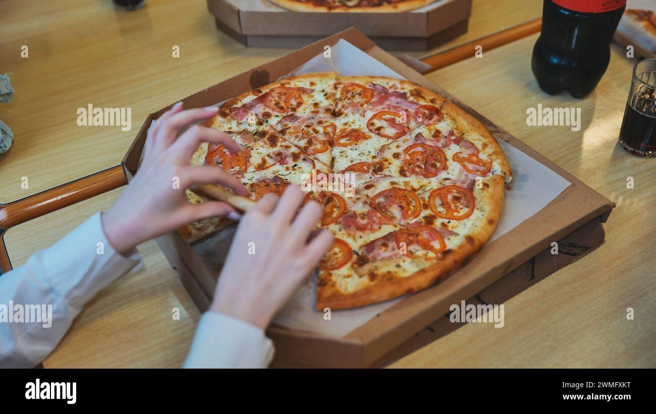 Students take a slice of pizza in the cafeteria Stock Photo - Alamy