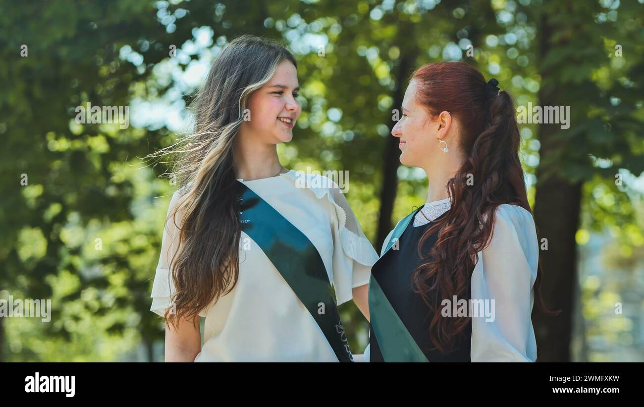 Two Russian schoolgirls graduate posing on a summer day Stock Photo - Alamy