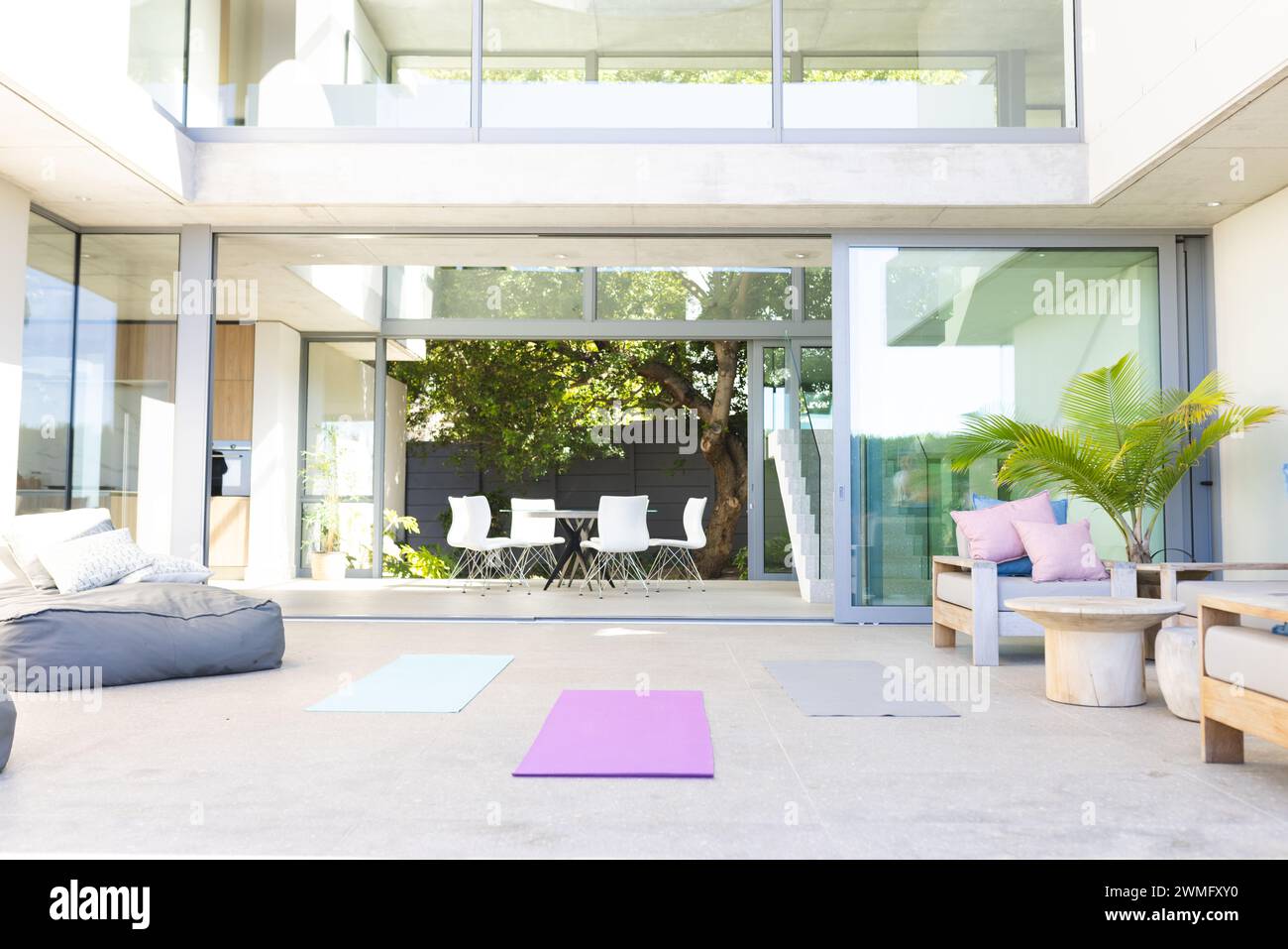Modern home patio with open sliding doors and yoga mats laid out Stock ...