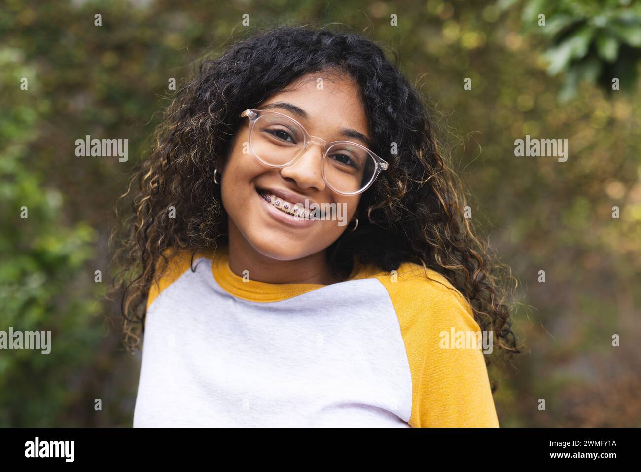 A teenage girl smiles brightly outdoors Stock Photo - Alamy