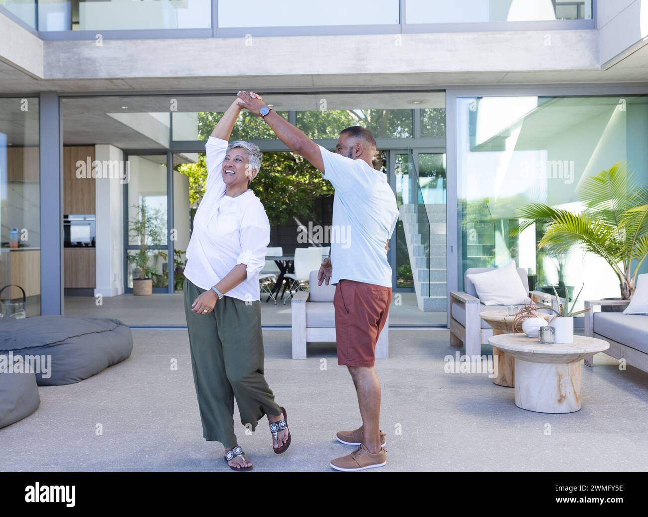 Senior biracial couple dancing joyfully outdoors Stock Photo - Alamy