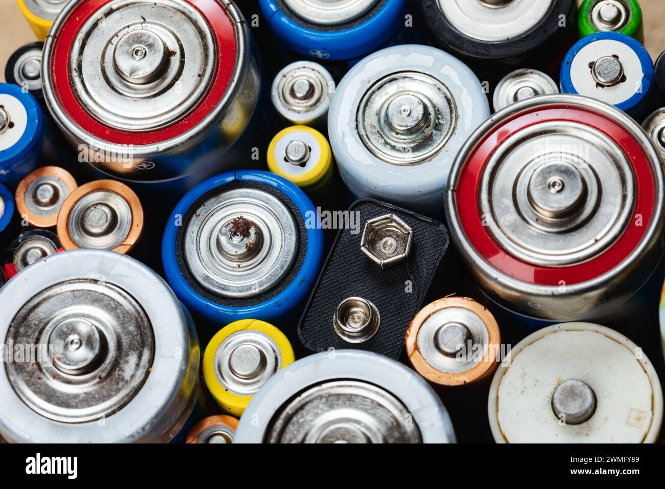 Close-up view of various used disposable alkaline batteries showcasing ...