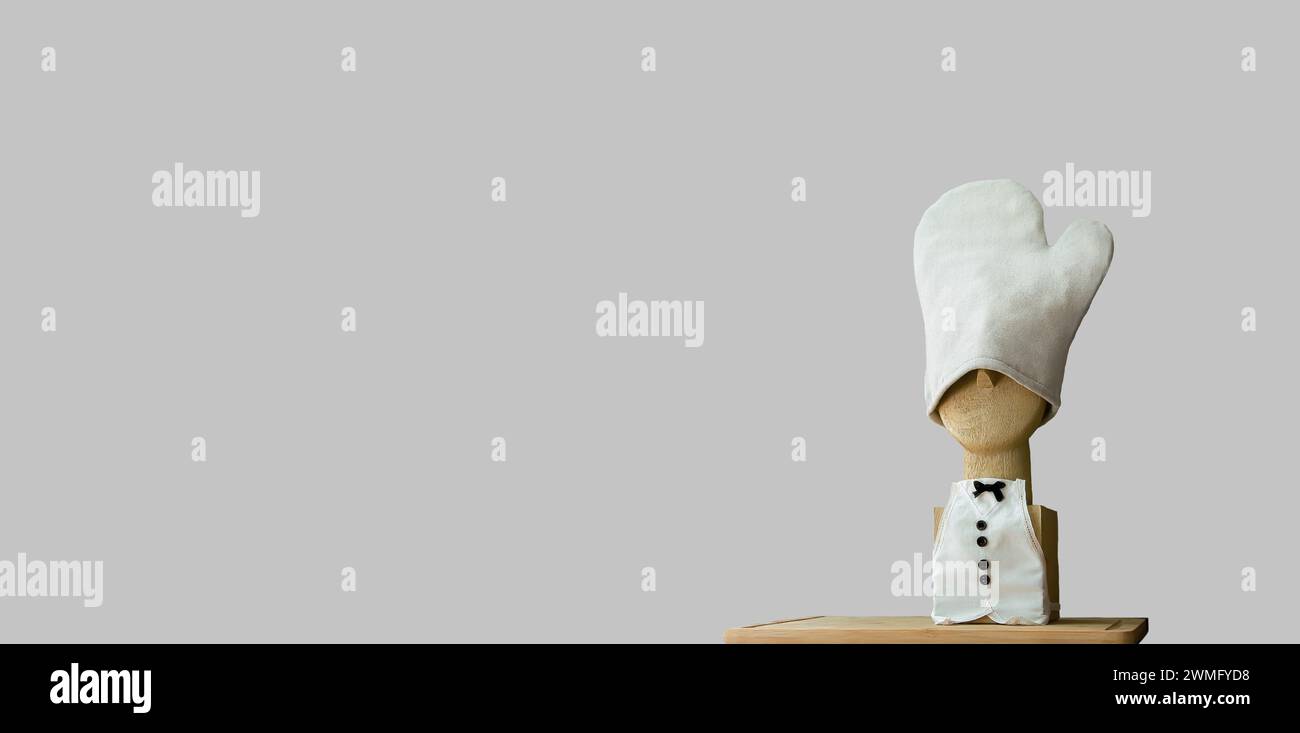 Chef's profile. A wooden bust sculpture with a miniature linen apron ...