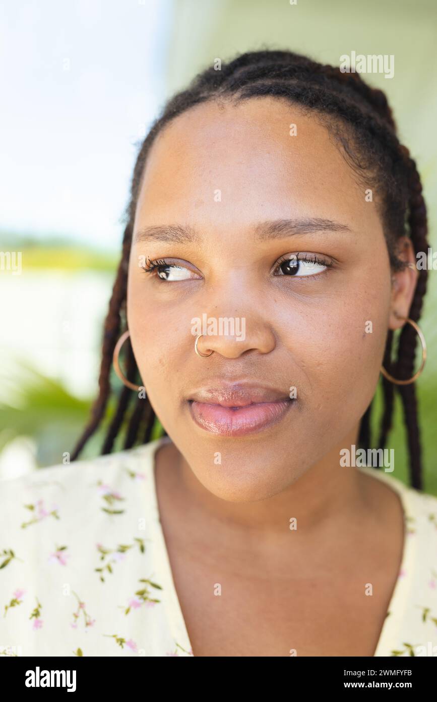 Young biracial woman looks thoughtfully to the side Stock Photo - Alamy