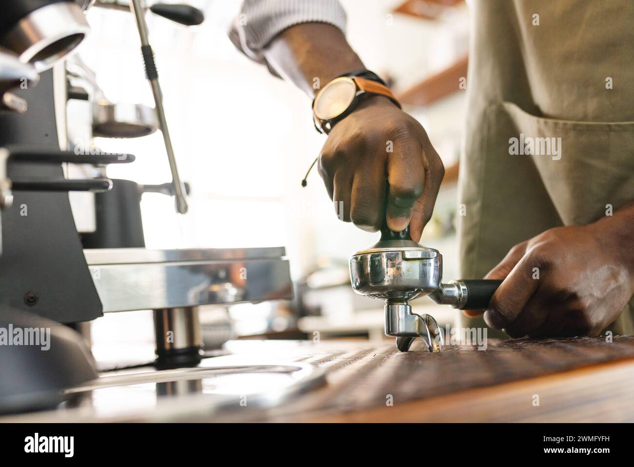 African American barista prepares coffee at a cafe Stock Photo - Alamy