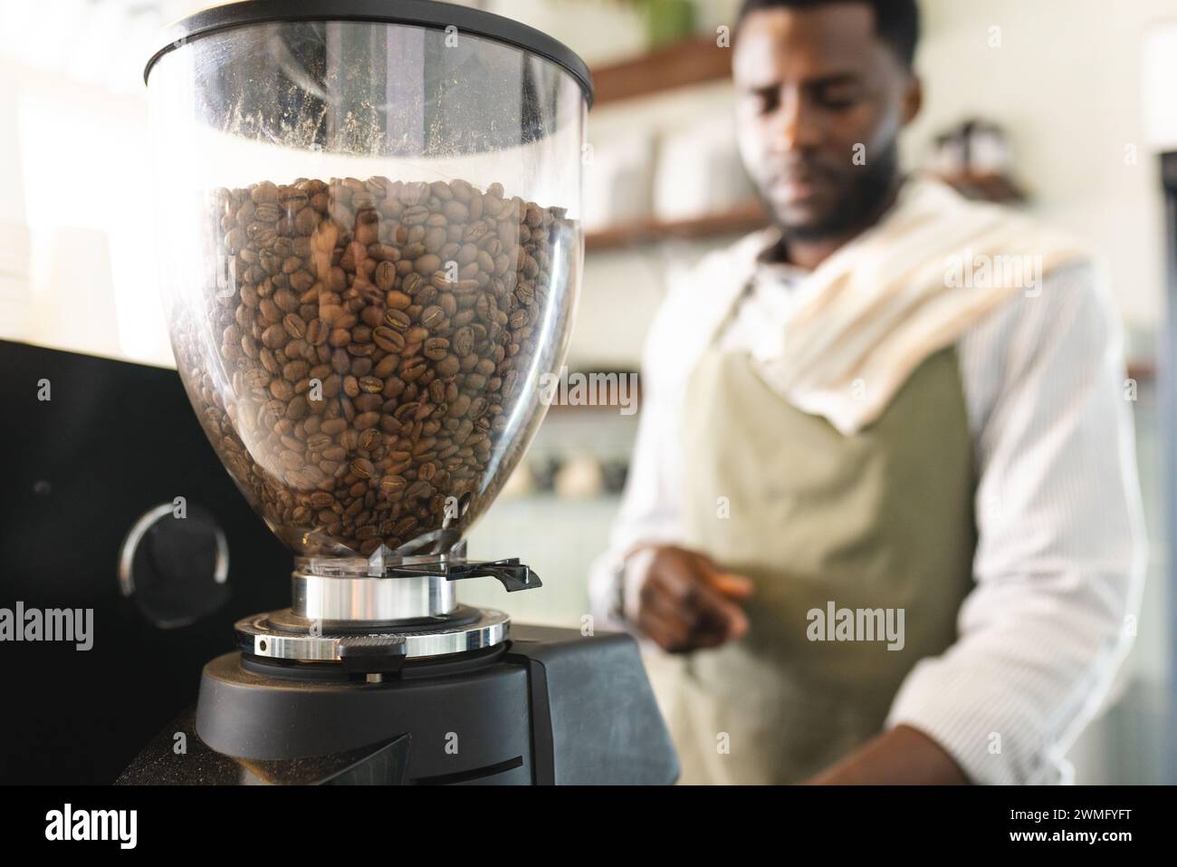 African American barista prepares coffee in a cafe Stock Photo - Alamy
