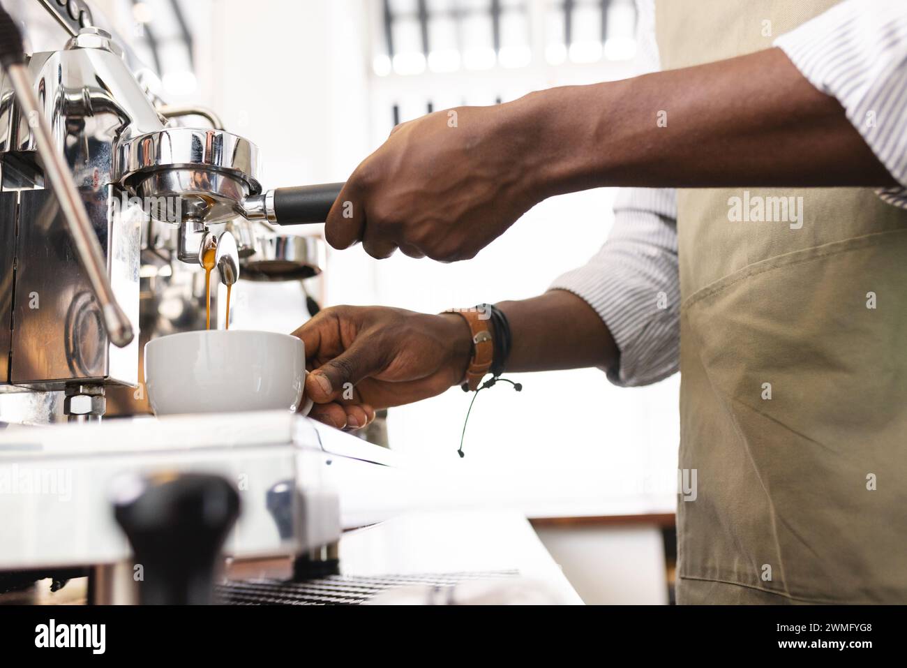 African American barista prepares coffee at a cafe Stock Photo - Alamy