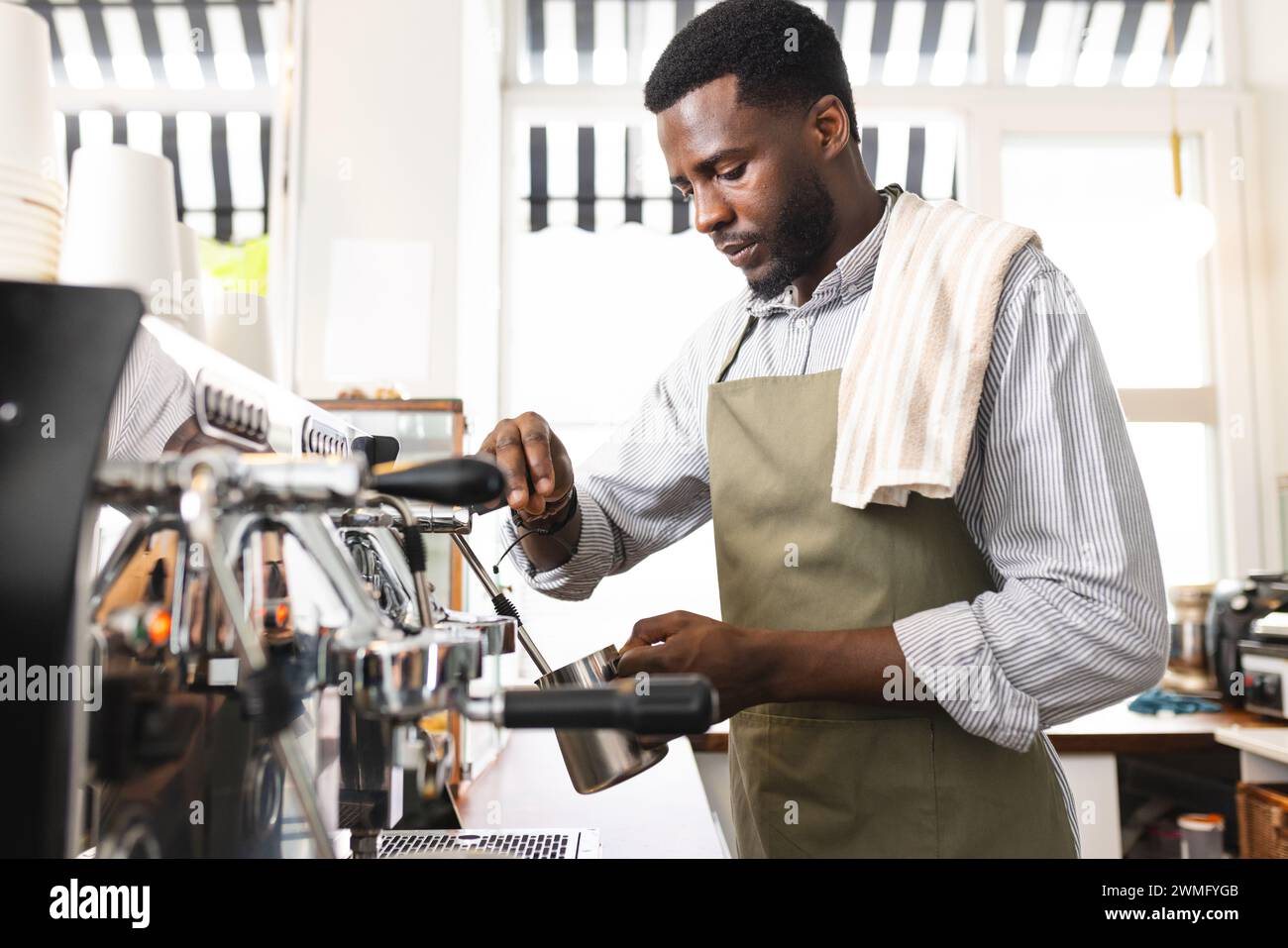 African American barista prepares coffee at a cafe Stock Photo - Alamy