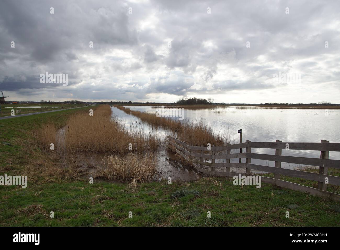 Ditch, meadows with much water from the rain. Dark clouds. Near the ...