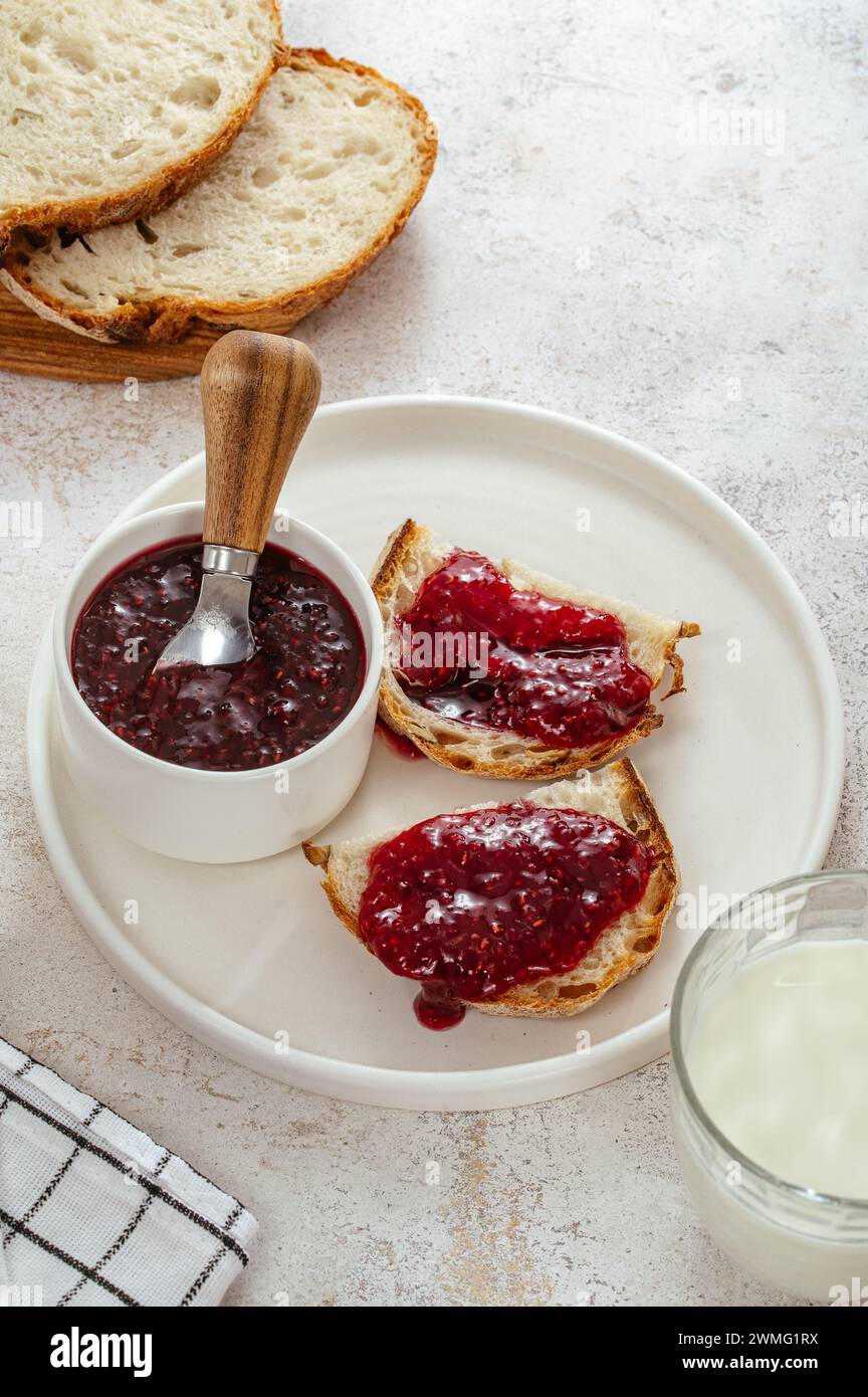 raspberry jam on bread on a plate Stock Photo - Alamy