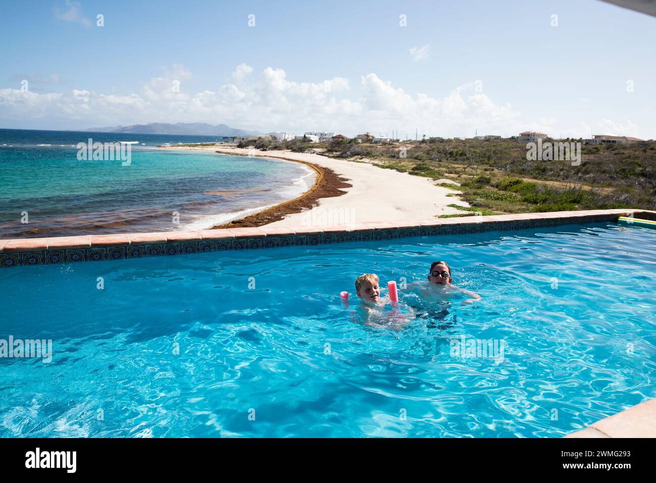 Smiling Brothers Look at Camera in Infinity Pool in Caribbean Stock ...