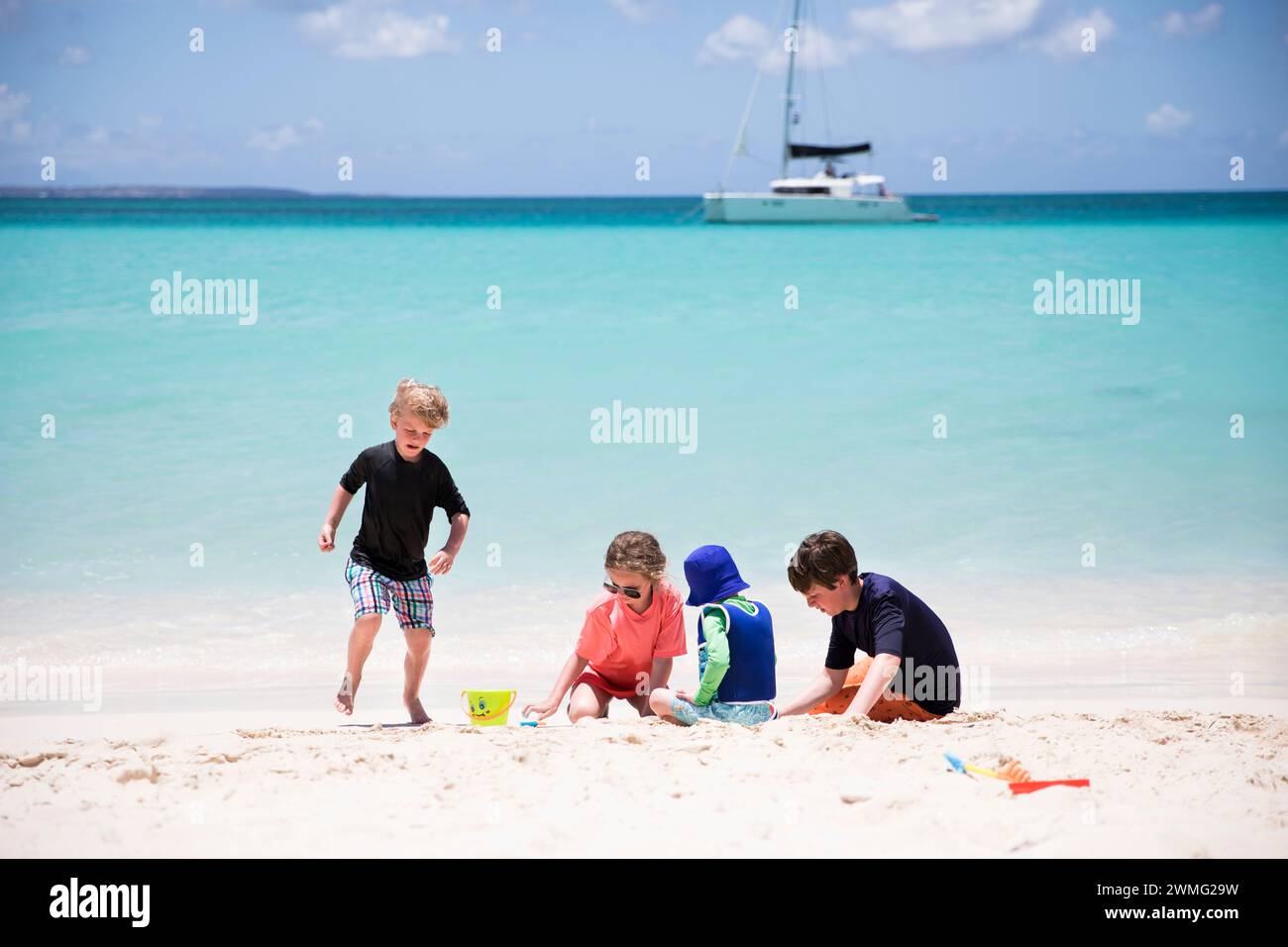 Four Siblings Build Sand Castle on Caribbean Beach Stock Photo - Alamy