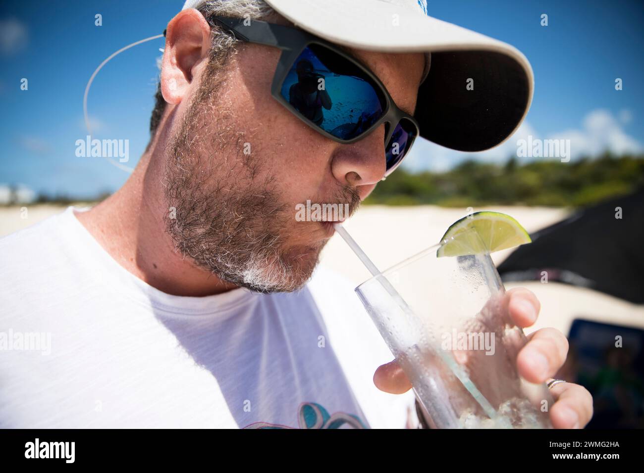 Millennial Man Makes Silly Face Drinking Cocktail on Caribbean Beach ...