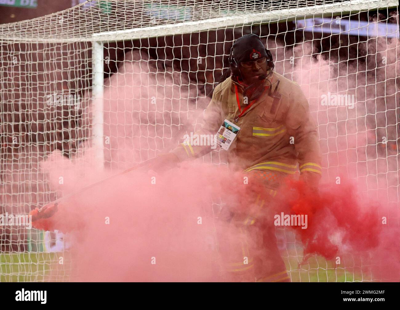 A fire officer with a red flare at the Chelsea v Liverpool Carabao Cup ...
