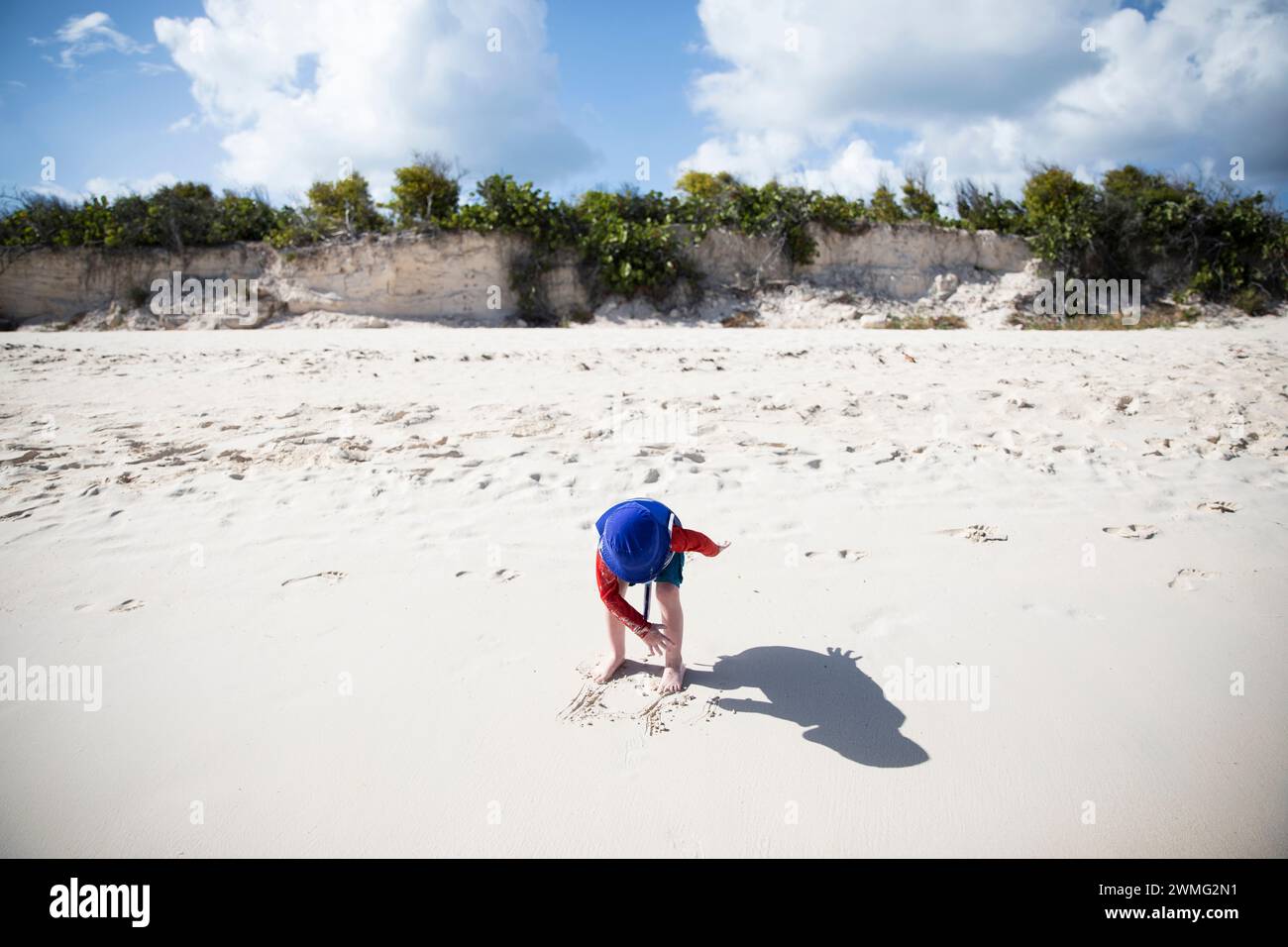Wide Angle of Toddler Boy in Blue Bucket Hat and Shadow on Beach Stock ...
