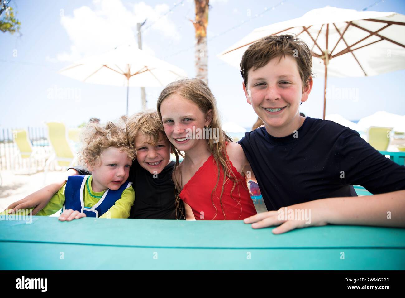 Brothers and Sisters Pose at Turquoise Picnic Table While on Vacation ...