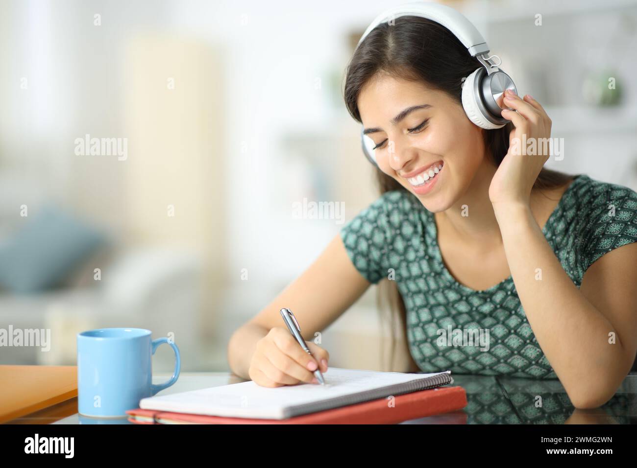 Happy student with headphone studying listening audio guide and taking ...