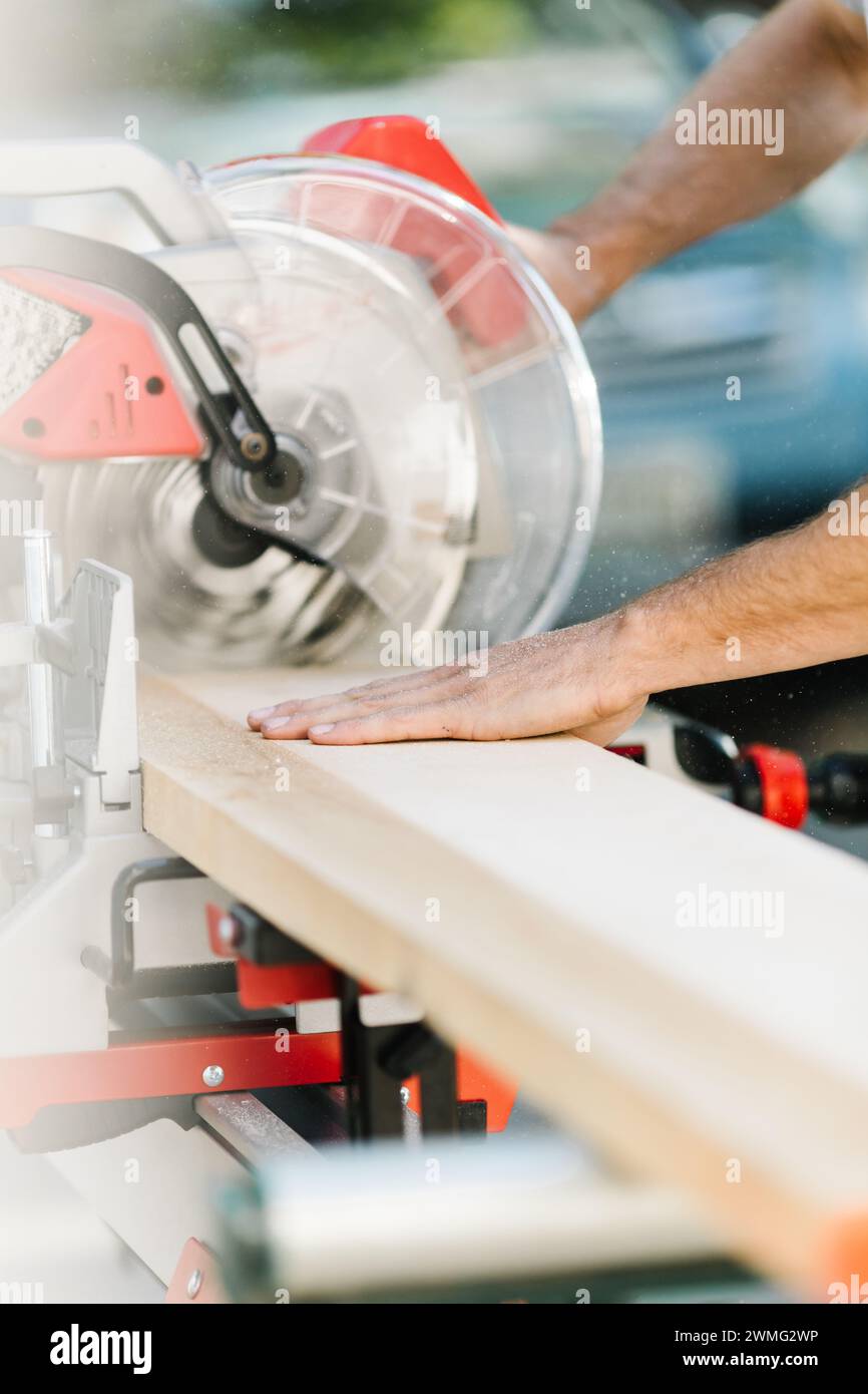Carpenter using miter saw for woodwork precision Stock Photo - Alamy