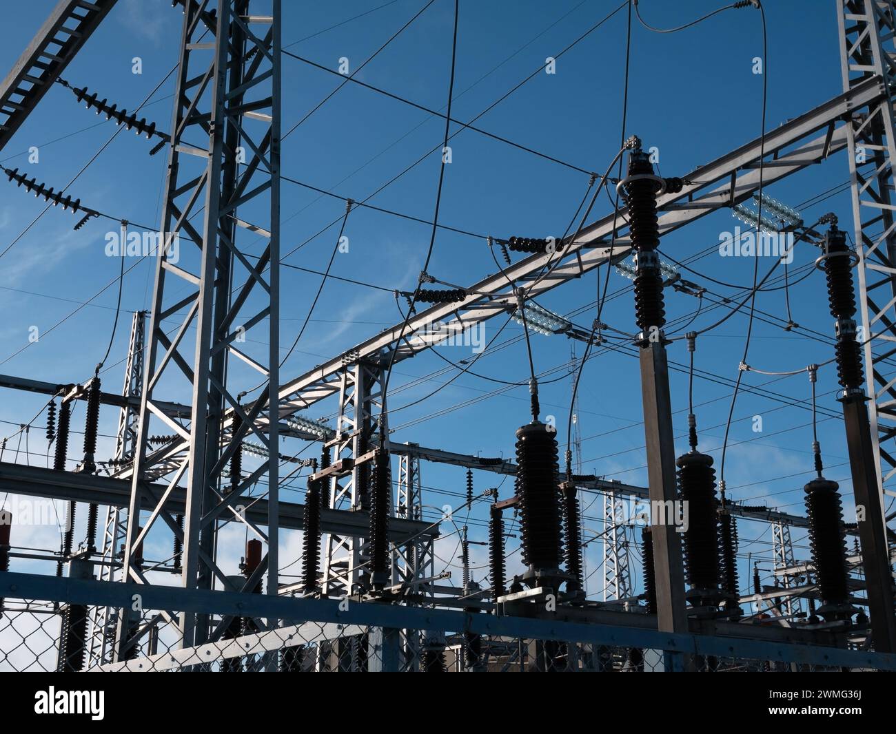 high-voltage power lines of transformer substation against the blue sky ...