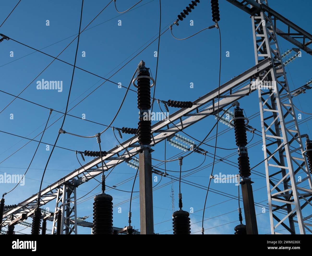 high-voltage power lines of transformer substation against the blue sky ...